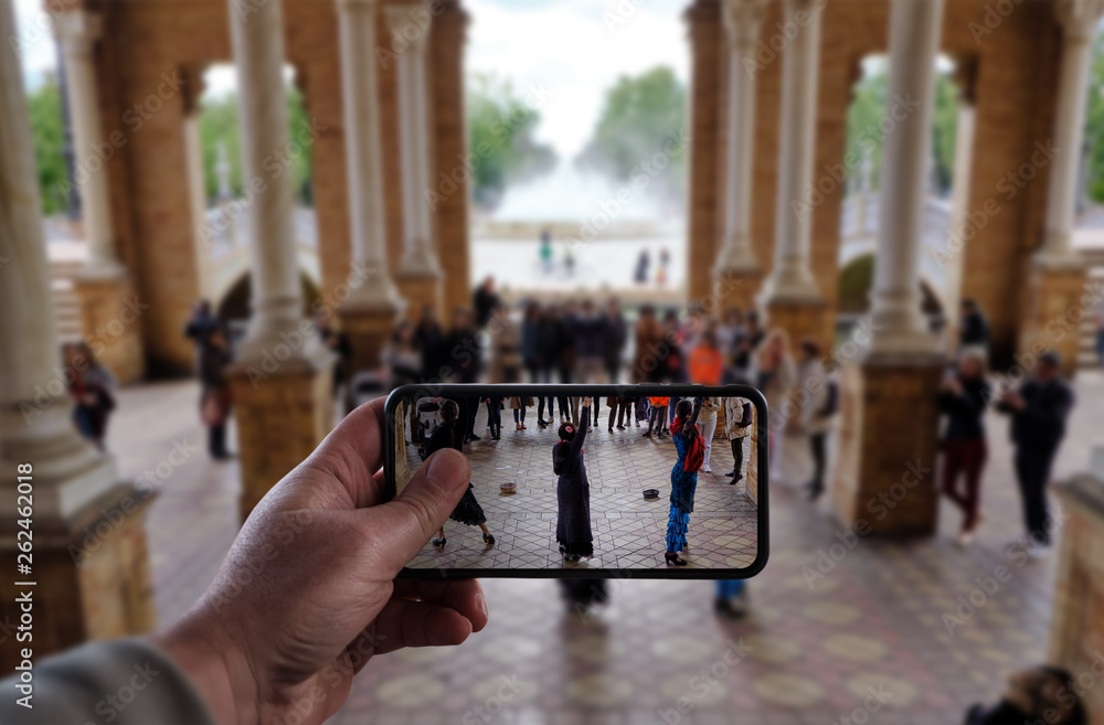 Man hand take a photo with smart phone to traditional spanish street ...