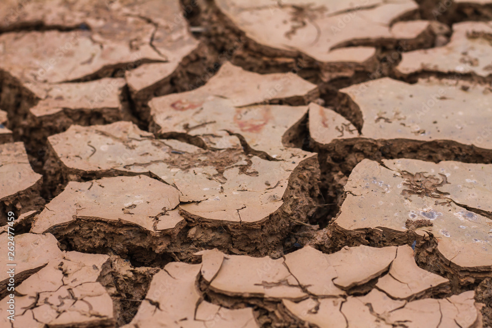 Deep cracks earth in the red land as a symbol of hot climate and ...