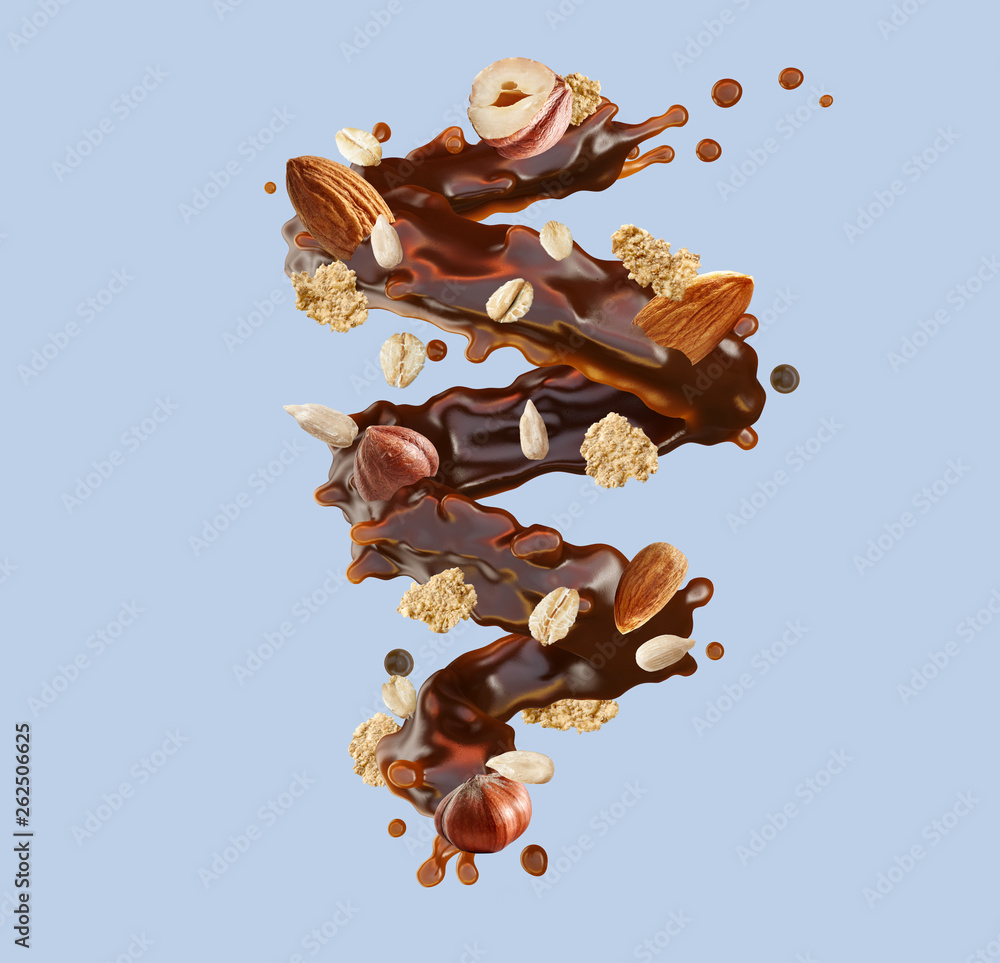 Melted dark chocolate or chocolate syrup splash wave with cereals, nuts ...