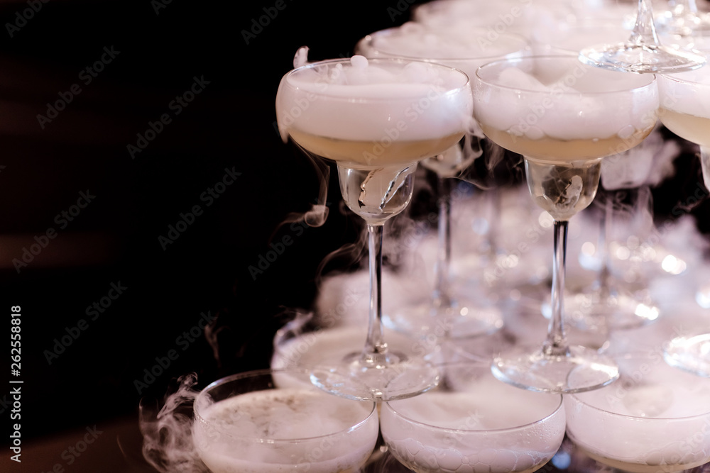 pyramid with cocktails. Beautiful row pyramid line of different colored ...