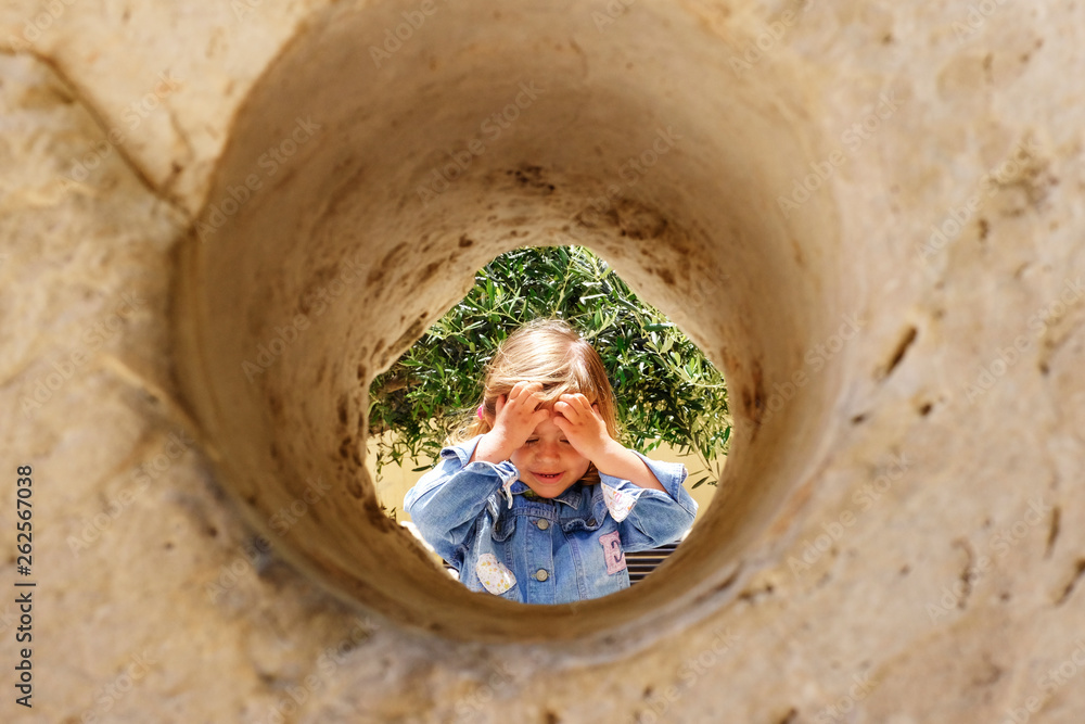Little girl photographed in the stone circle of an olive grindstone in ...