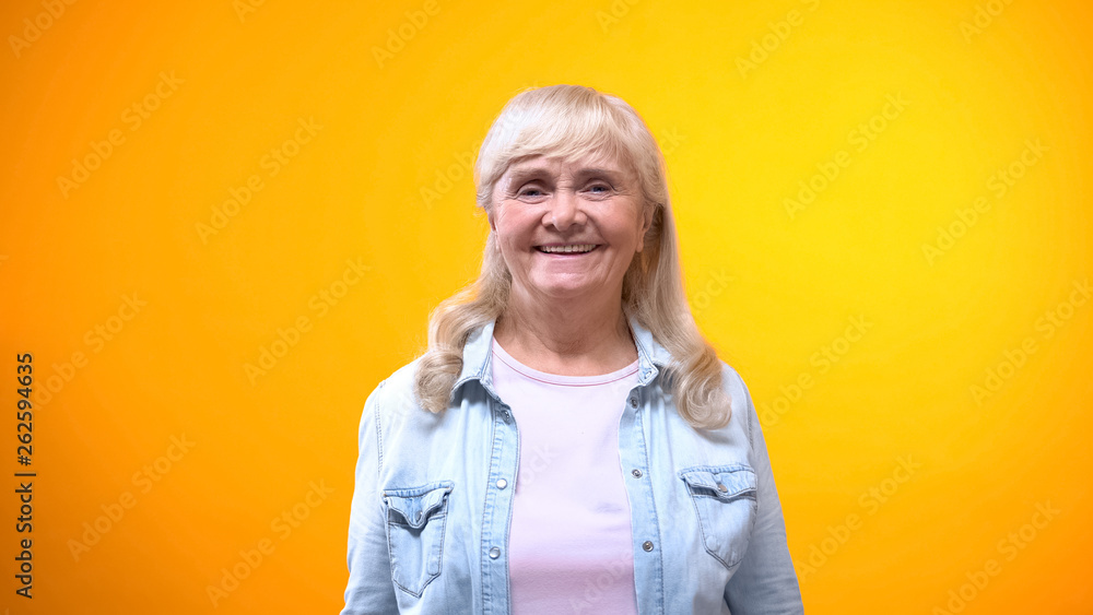 Friendly old lady smiling on camera, concept of satisfied customer ...