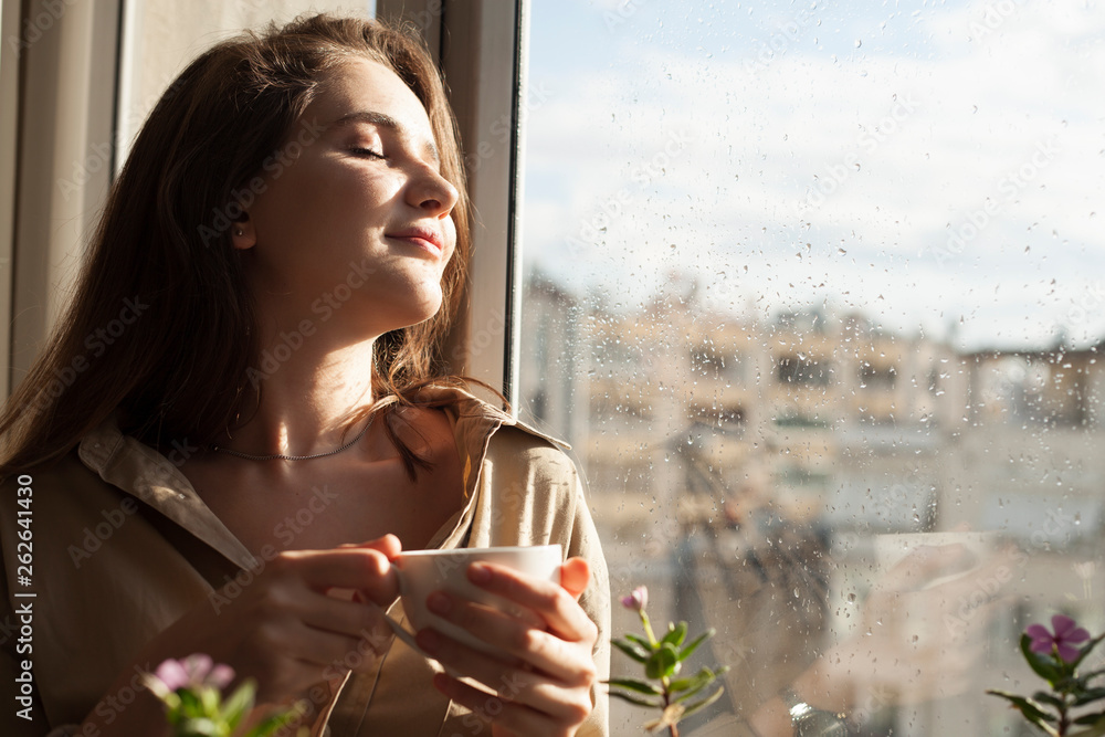 sad woman thinking at window Stock Photo | Adobe Stock
