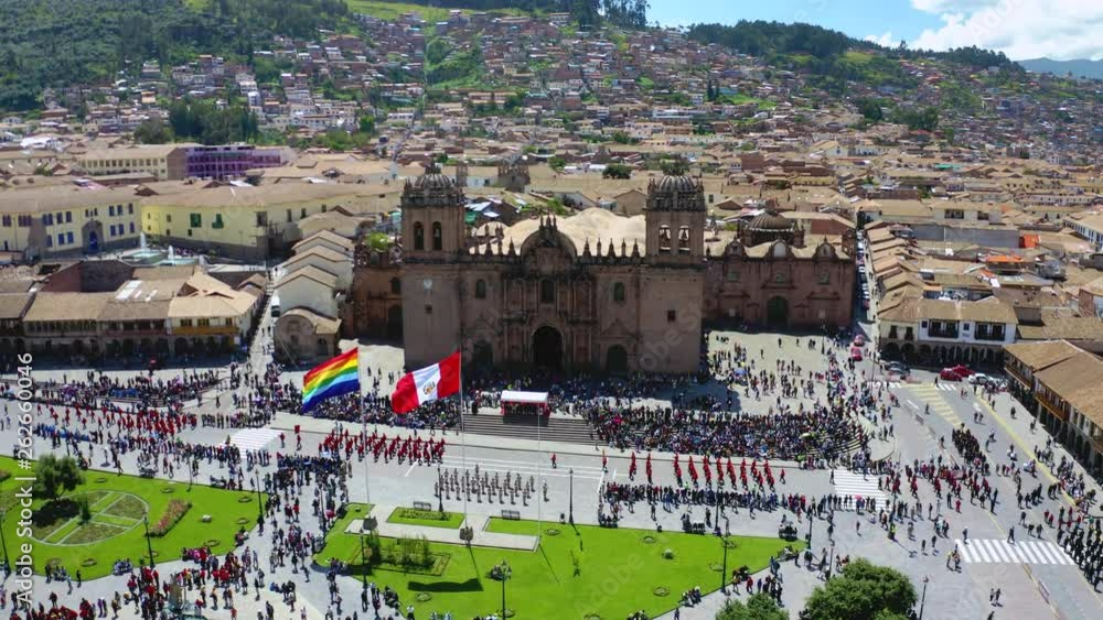 Aerial view of Cusco's main plaza with parade and crowd of people ...