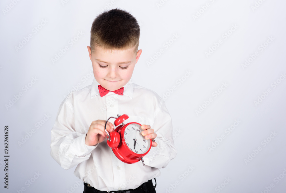It is time. Morning routine. Schoolboy with alarm clock. Kid adorable ...