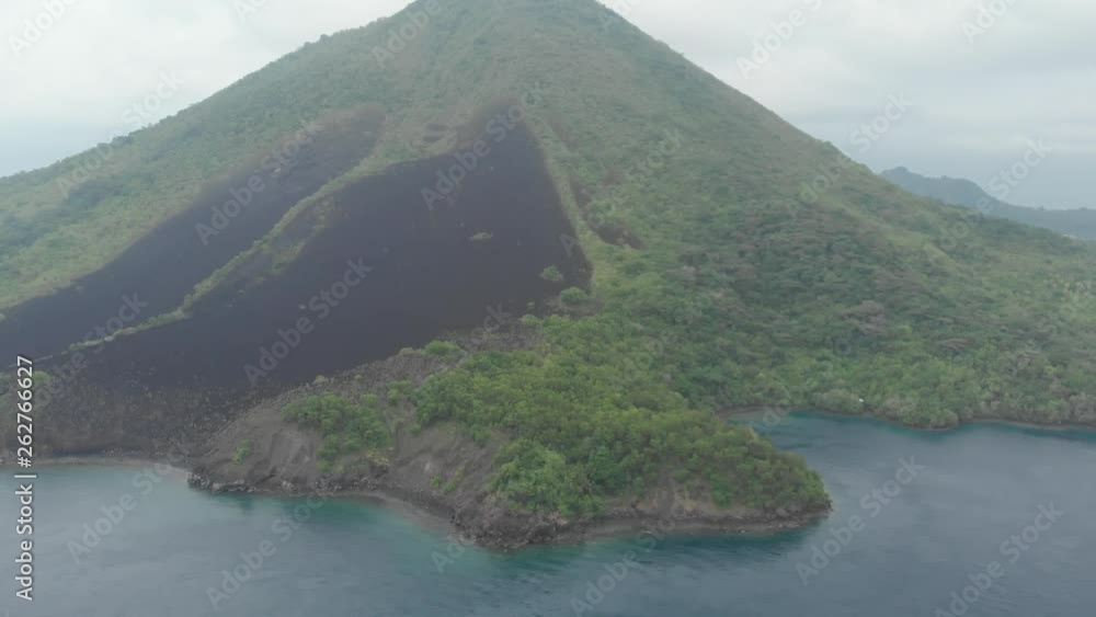 Aerial: flying over Banda Islands active volcano Gunung Api lava flows ...