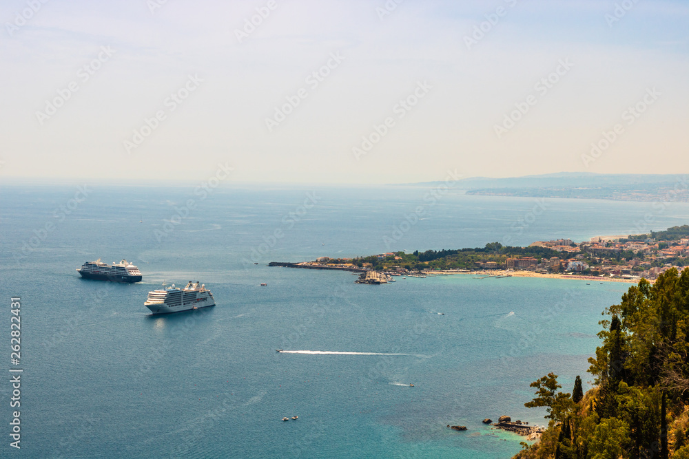 Taormina, Italy - 2019. Panorama of Giardini Naxos bay and cruise ships ...