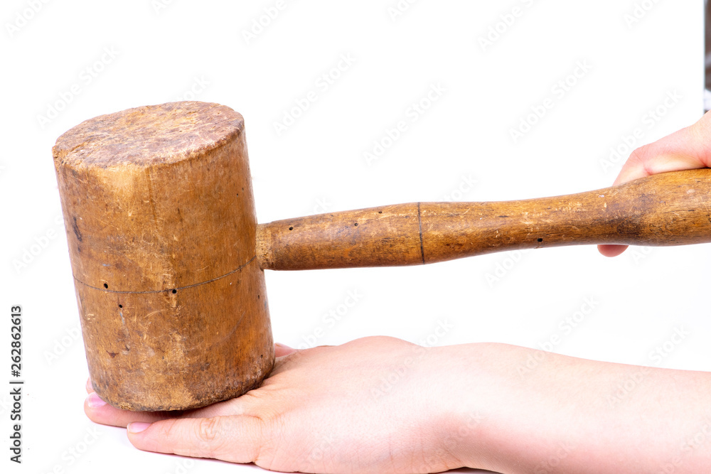 boy hitting his hand with a big wooden hammer Stock Photo | Adobe Stock