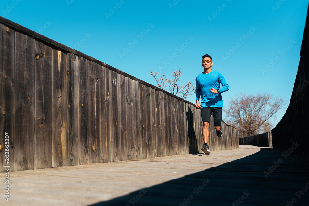 Handsome asian man running in the park. Stock Photo | Adobe Stock