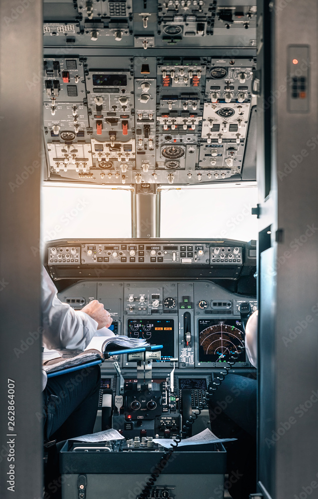 Pilot and copilot inside a cabin flying an airplane. Stock Photo ...