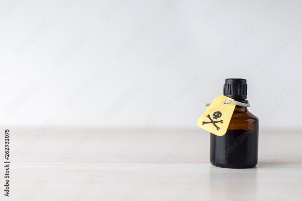 dark jar with poisonous solution, etiquette with a warning sign about ...