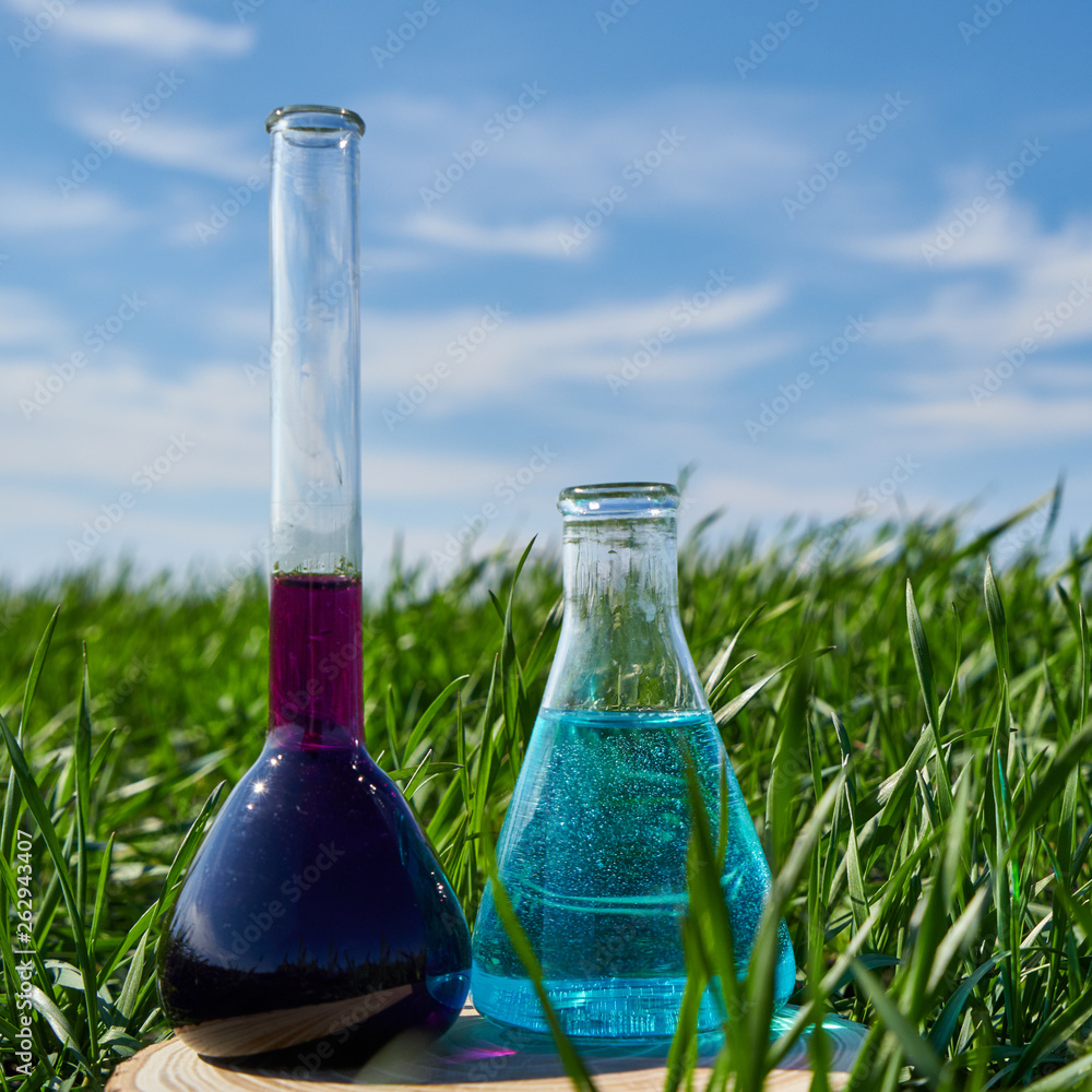 Image of a glass flask with a chemical solution on the background of ...
