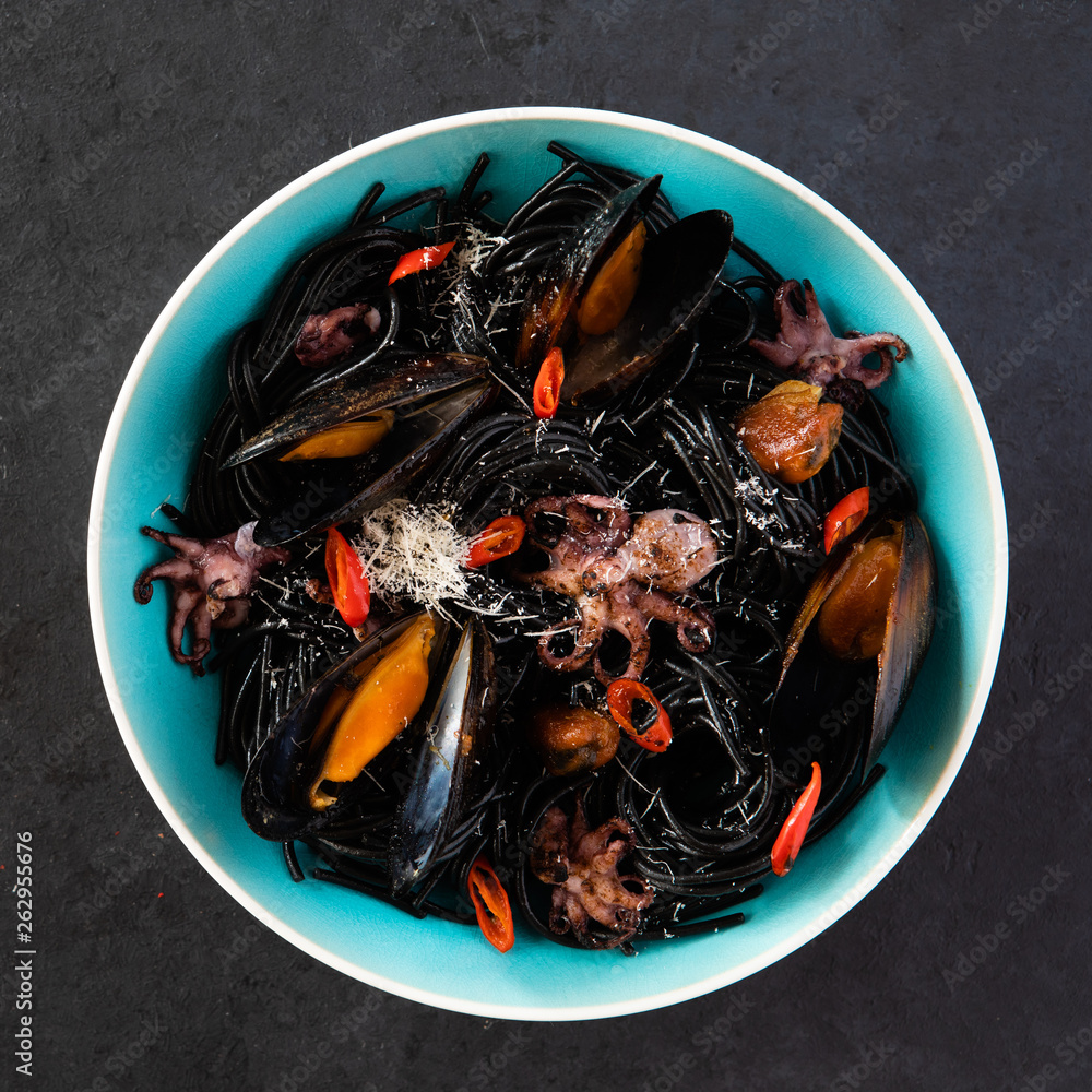 Top view of mediterranean black pasta with seafood. Spaghetti Nera with ...