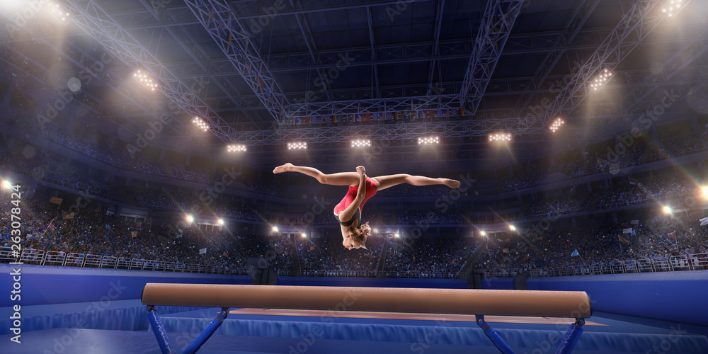 Female athlete doing a complicated exciting trick on gymnastics balance ...