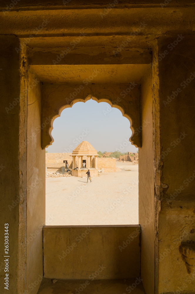 Looking out an arched stone window of rajasthani design onto the ...