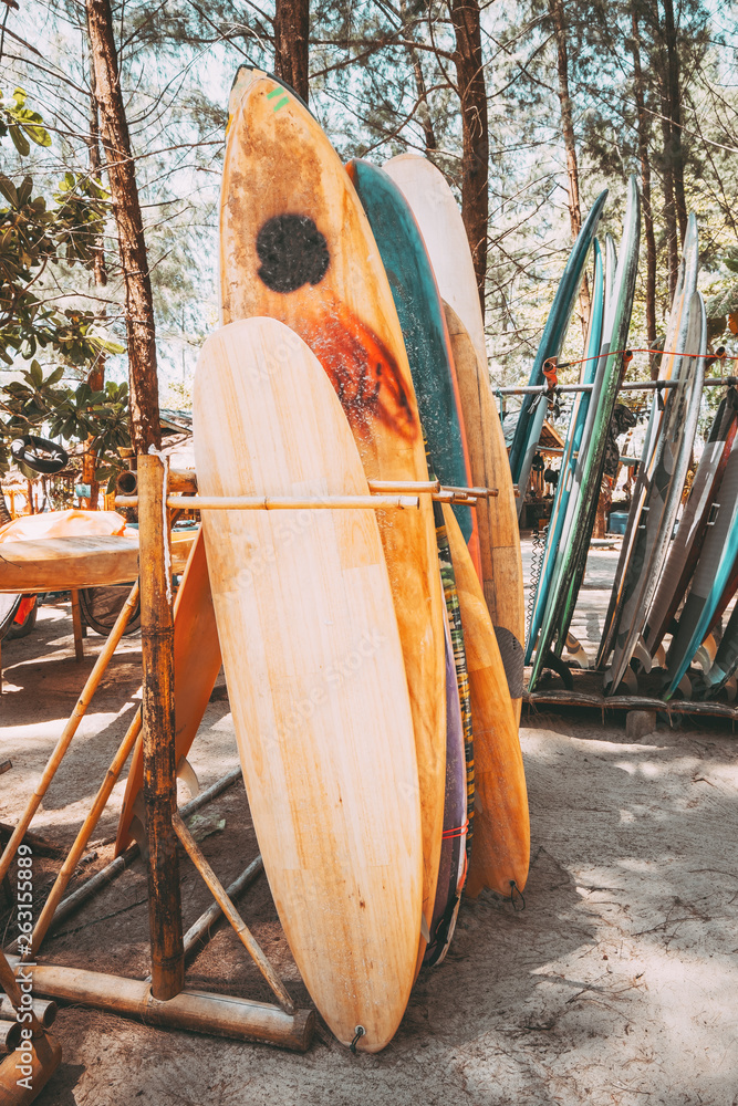 Set of different colorful surf boards in a stack available for rent on ...
