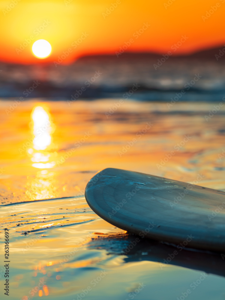 surfboard on the beach in sea shore at sunset time Stock Photo | Adobe ...