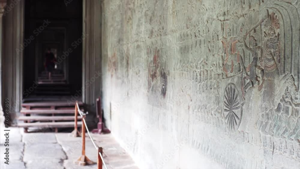 Ancient murals on the stone wall in Angkor Wat temple inner corridor ...