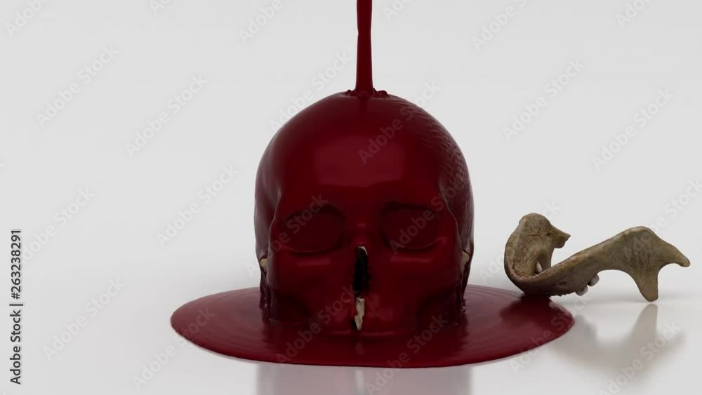 Human skull with separate jaw covered by a jet of blood flowing from ...