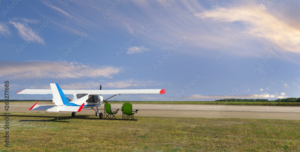 Rear side view of light aircraft with piston engine on airfield with ...