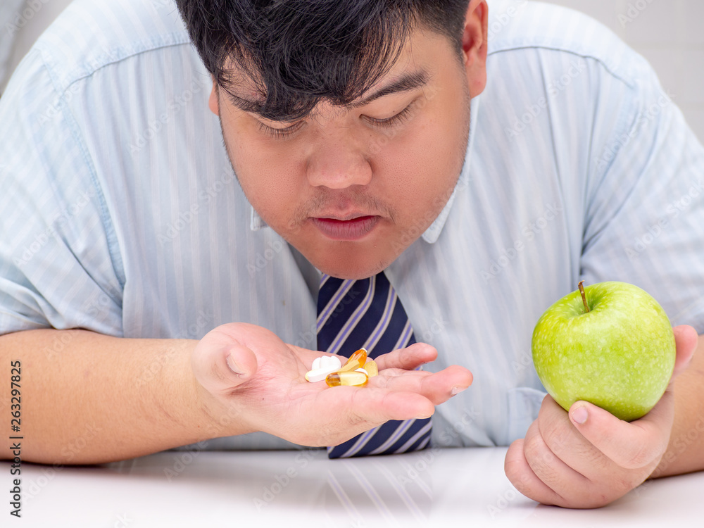 Fat man choosing pill and fruit for take care of health Stock Photo ...