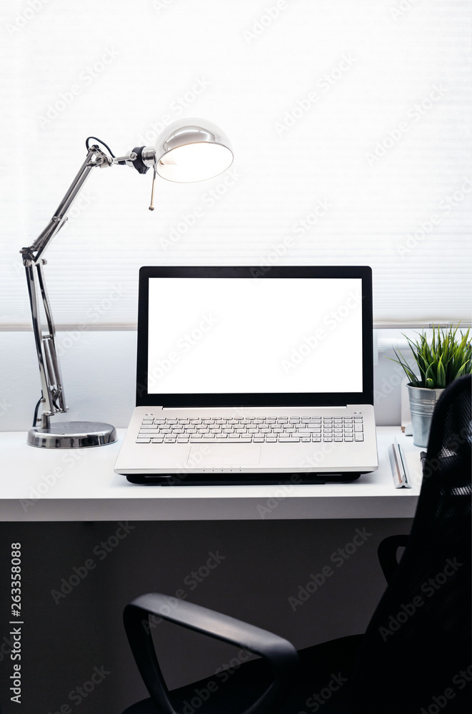 Computer notebook or laptop with white screen on office table with ...