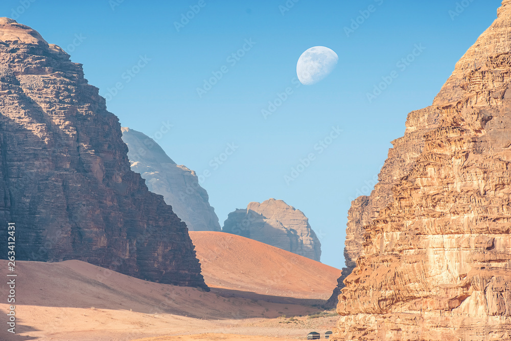 incredible lunar landscape with huge moon in Wadi Rum village in the ...