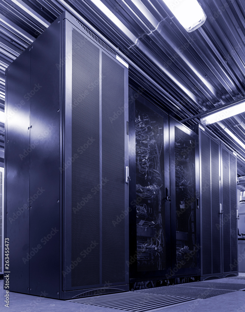 Rack server hardware in big data center with connected cables and wires ...