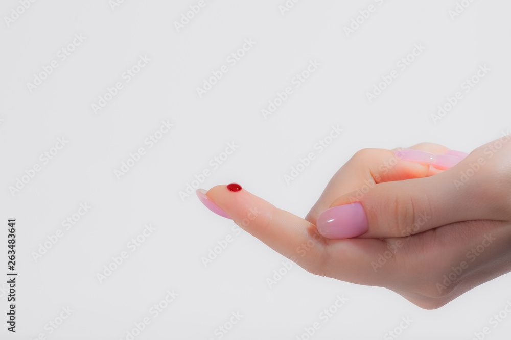 red drop of blood on the finger, female hand, blood test, unexpected ...