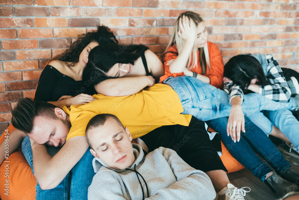 Team unity and bonding. Close friends colleagues sleeping on bean bags ...