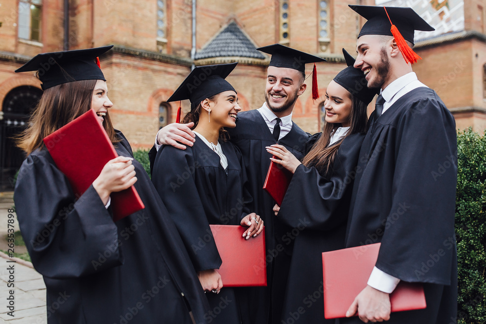 Happy graduation day. 5 graduates hold his graduate diplomas in their ...