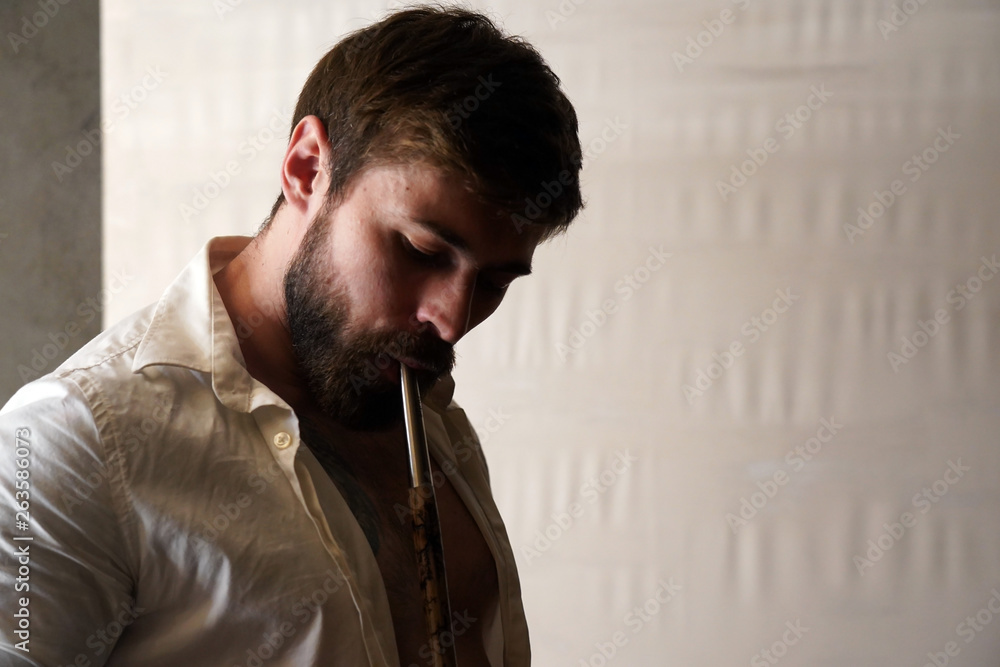 Portrait of a brutal bearded man with short brown hair in a white ...