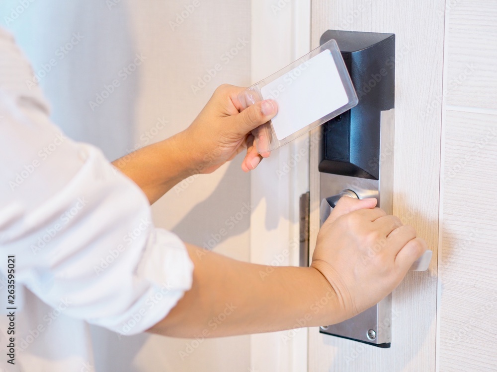 Security system is a door with a key card. The woman's hand is going to ...