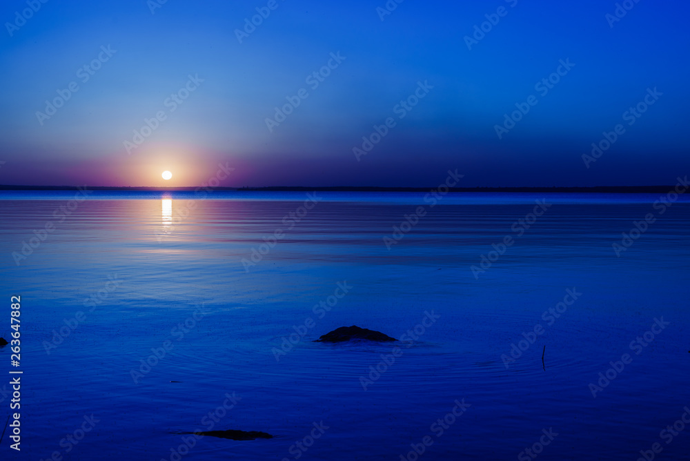 Reflection of a sunset by a lagoon inside the Amazon Rainforest Basin ...