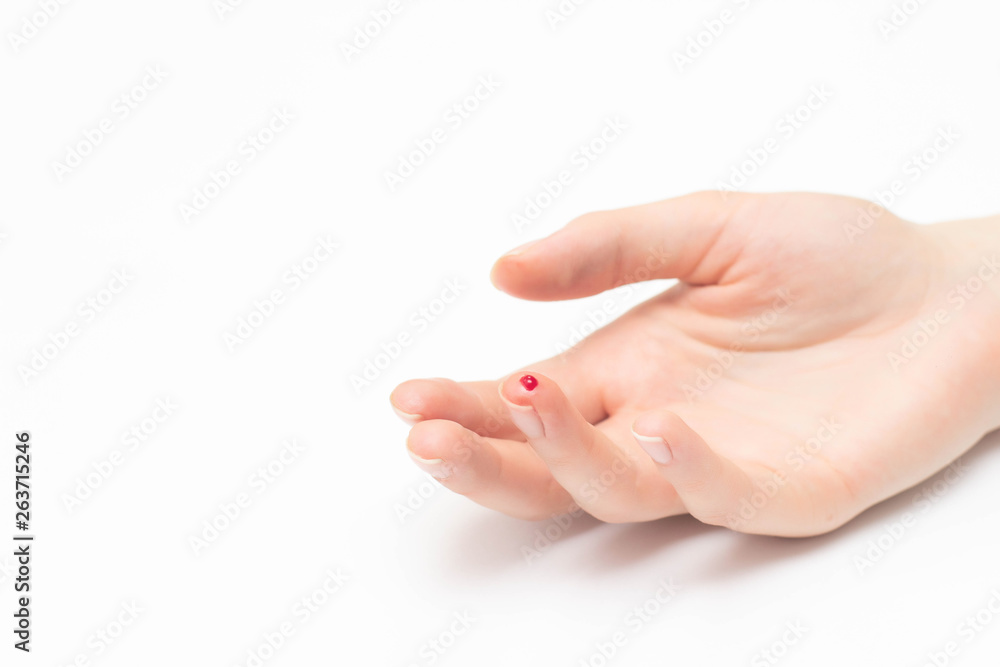 Female hand on white background and blood from a finger concept of a ...