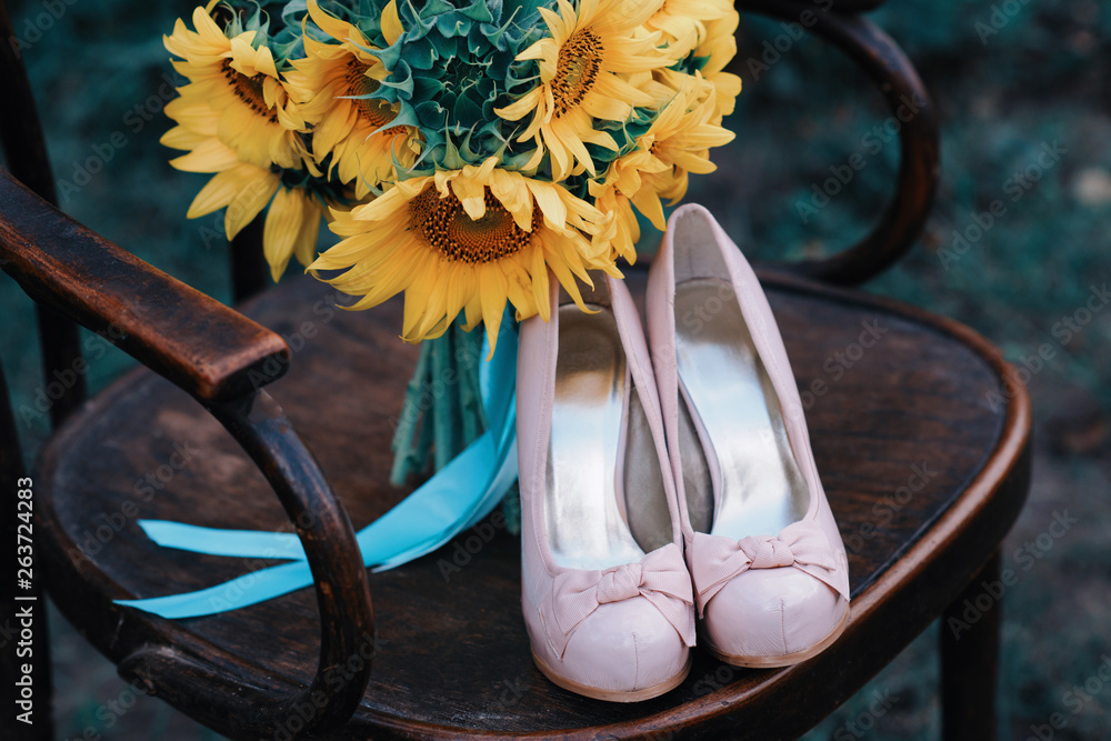 Beautiful wedding shoes with high heels and a bouquet of colorful ...