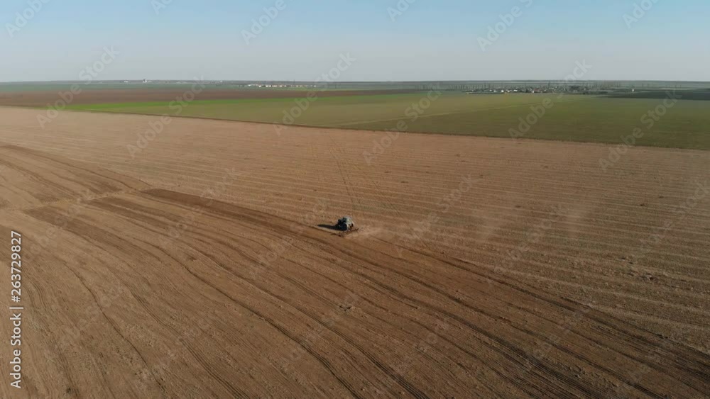 Aerial view of vintage tractor produces pre sowing soil preparation ...
