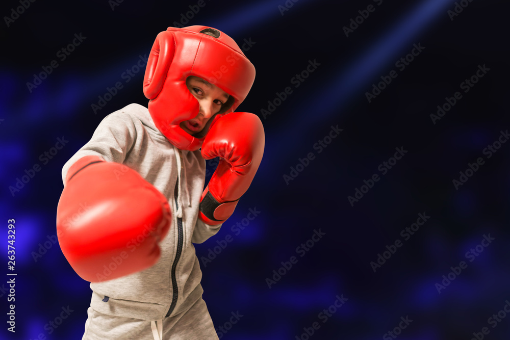 The boy in boxing gloves ready to fight. Young Boxer fighter over black ...