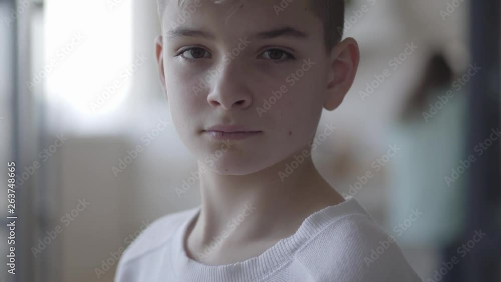 Close up face of a young man cute handsome teenager serious boy looking ...