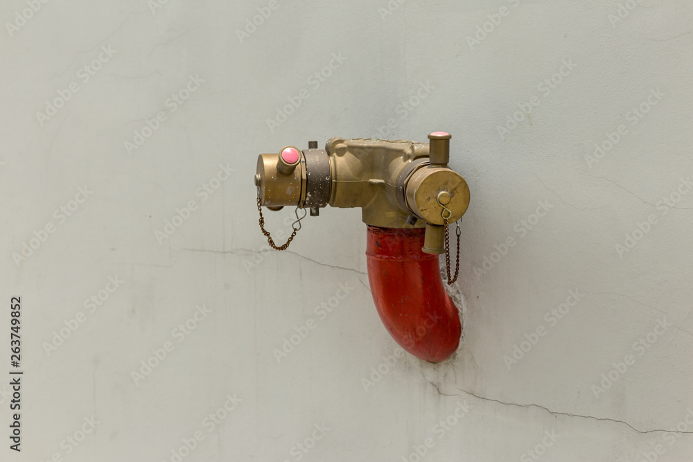 Red fire pump in front of concrete wall. fire safety pump on cement ...