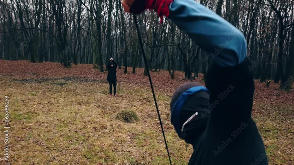 Ninja with a cable squares of against man with long sword in a forest ...