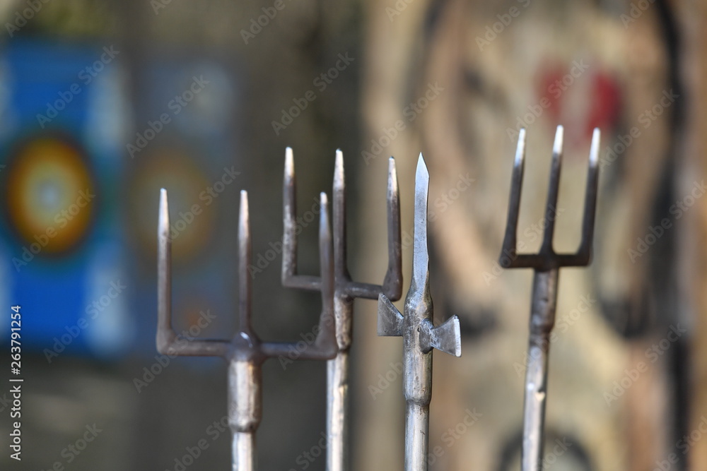 Four handmade iron forks for fighting on a market. Each of them with ...