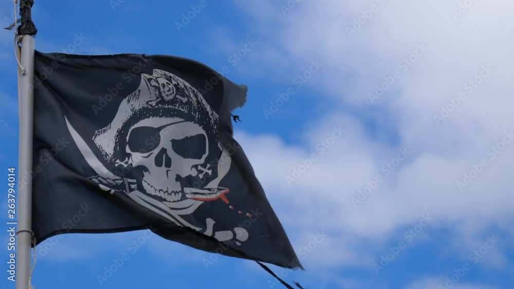 Black ragged pirate flag with bloody knife between skull teeth and ...