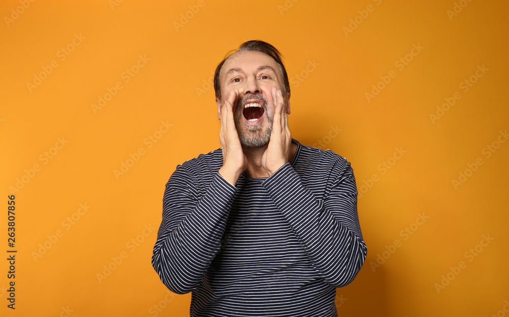 Portrait of screaming mature man on color background Stock Photo ...