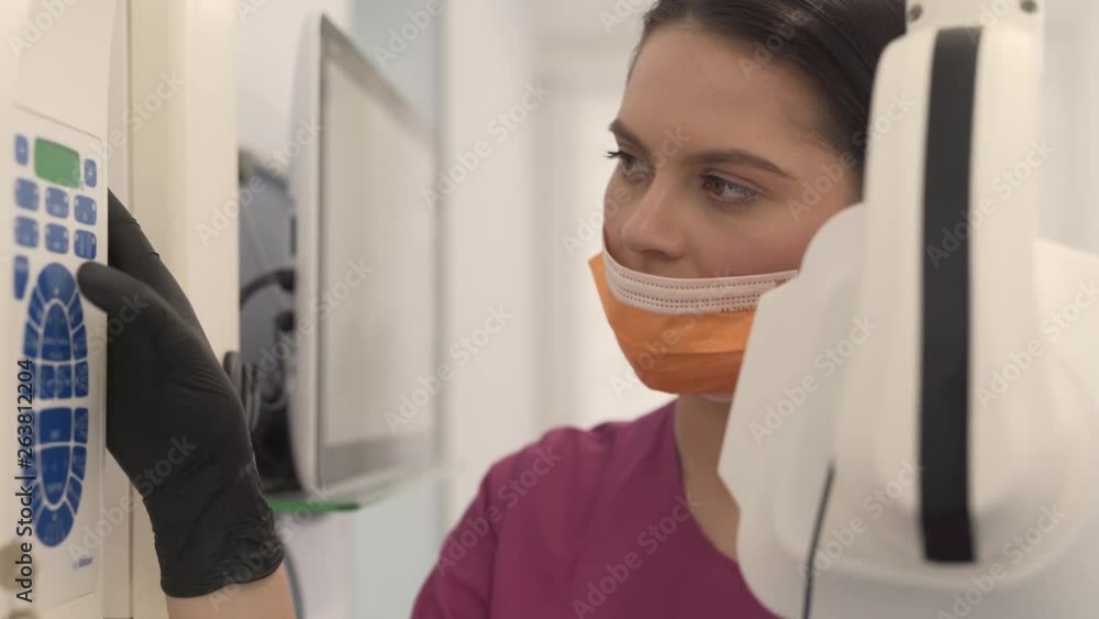 Female Dentist in Private Clinic Setting Values on Wall Instrument With ...