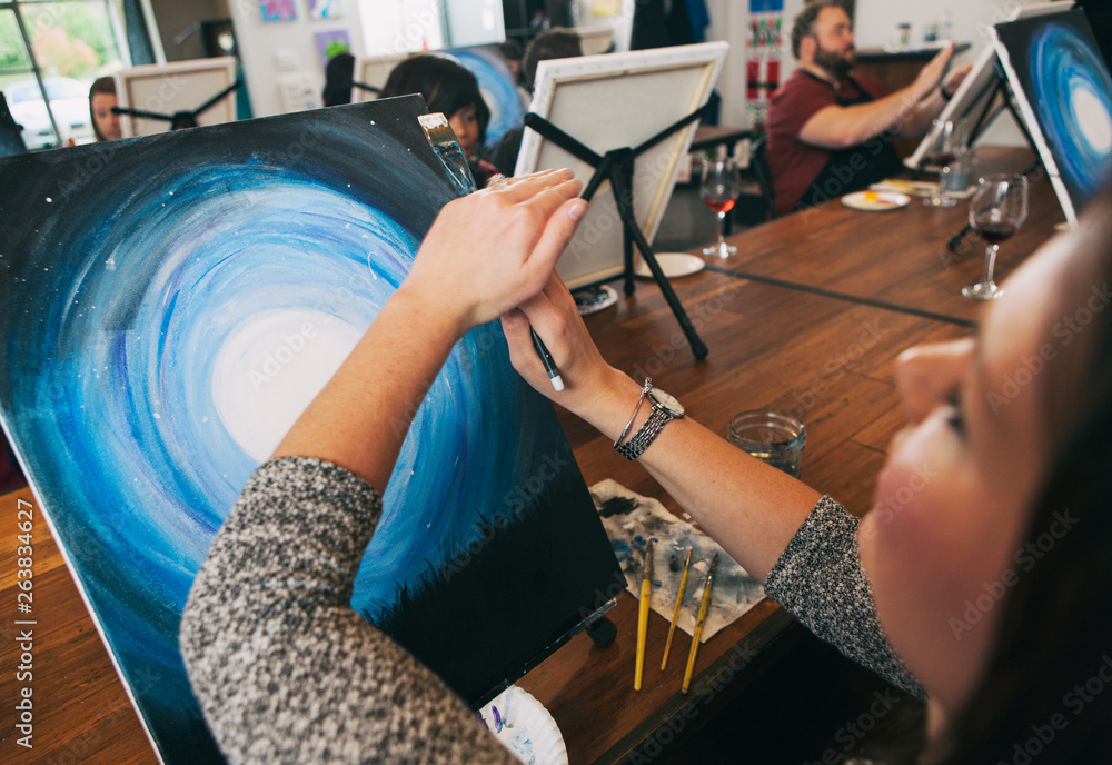 Painting: Woman Uses Spatter Technique To Make Stars On Canvas Stock ...