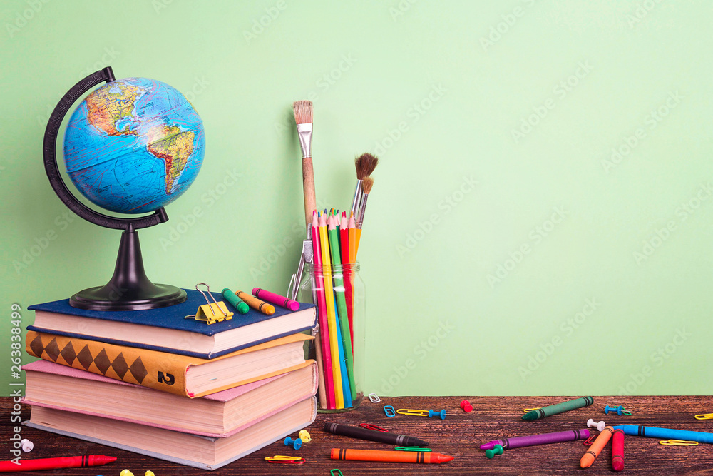 Education composition with a globe, a stack of books and school ...