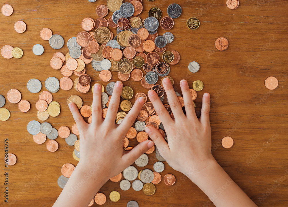 Child's hands counting coins Stock Photo | Adobe Stock