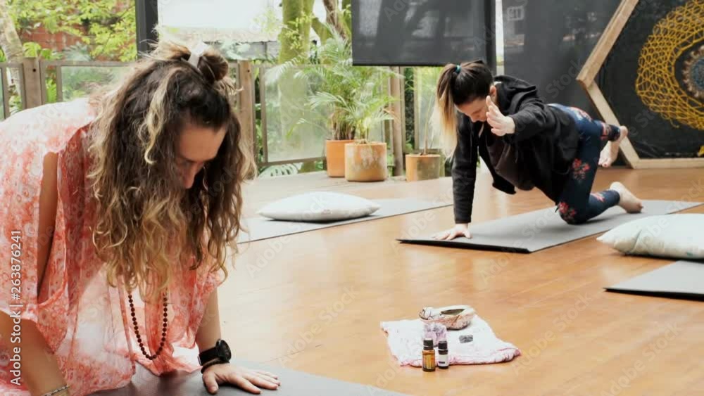A yoga student in a classroom, during a lesson, mimicking a position ...