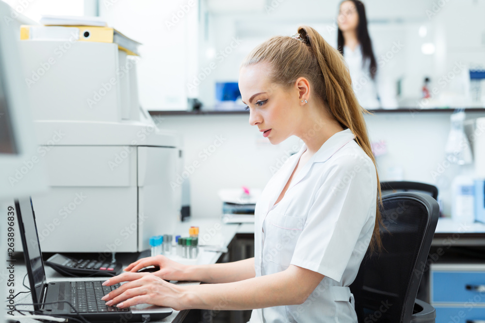 Modern technology in science. Scientist entering data of analysis or ...